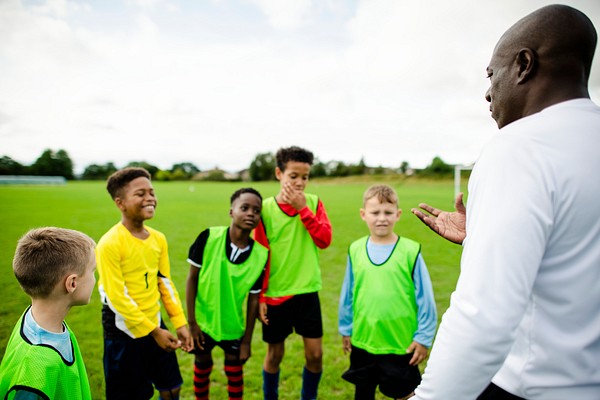 Football coach training his students | Free Photo - rawpixel