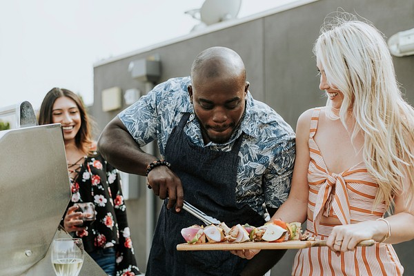 Happy friends grilling barbeque at a rooftop | Premium Photo - rawpixel