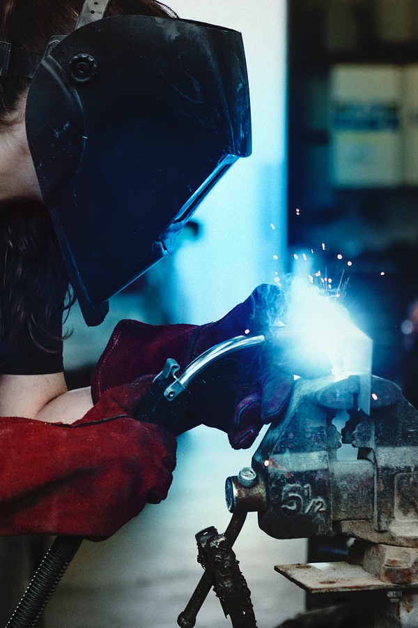 Female welding a metal piece | Free Photo - rawpixel