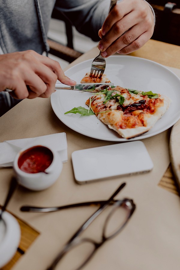 Man eating a slice of a pizza. | Free Photo - rawpixel