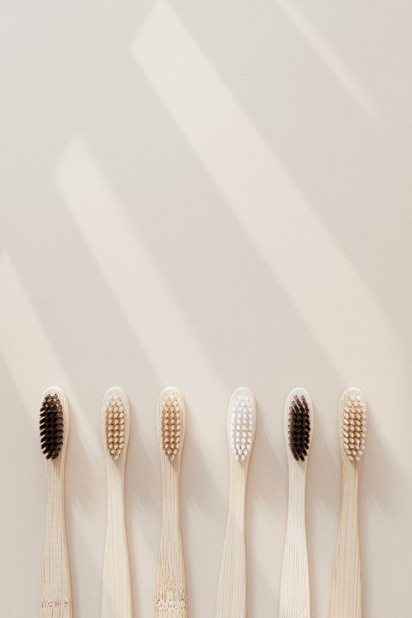 Natural wooden toothbrushes on beige | Premium PSD - rawpixel