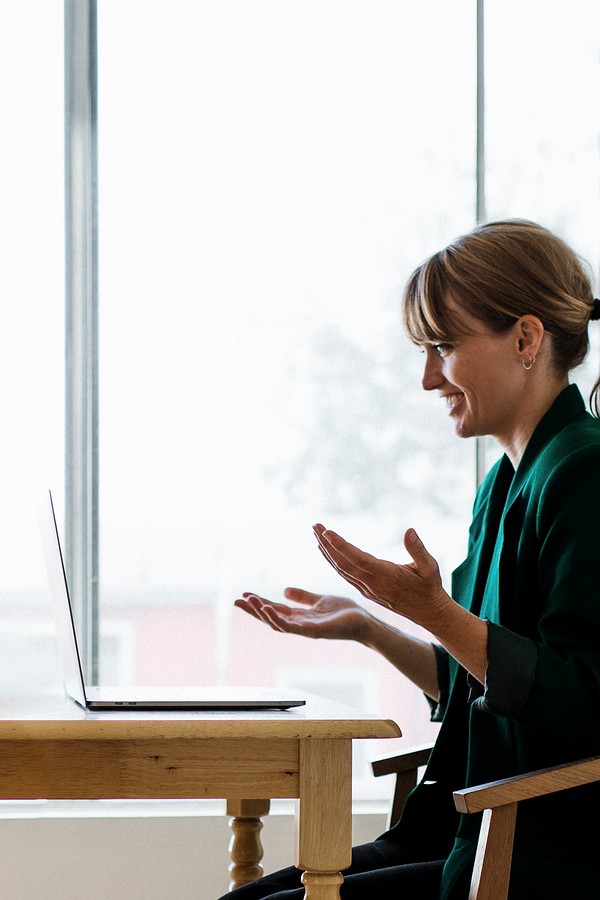 Cheerful woman video call while | Free Photo - rawpixel