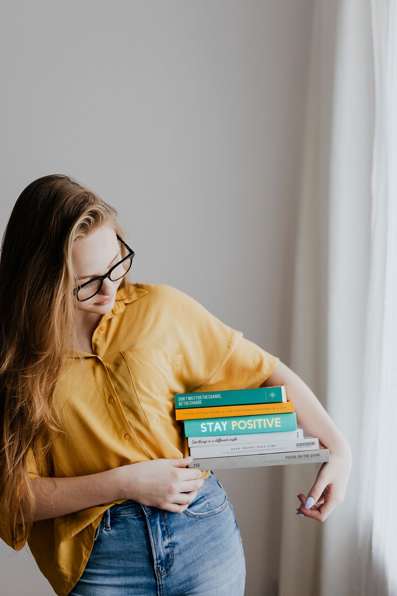 Cheerful blond girl carrying books | Premium Photo - rawpixel