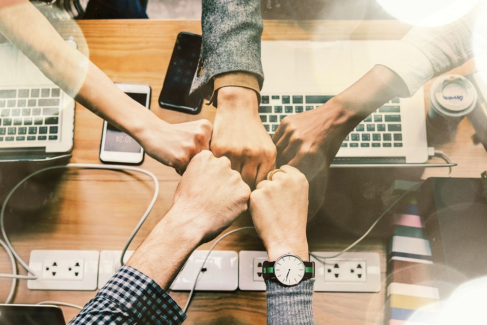 Colleagues giving a fist bump | Free Photo Illustration - rawpixel