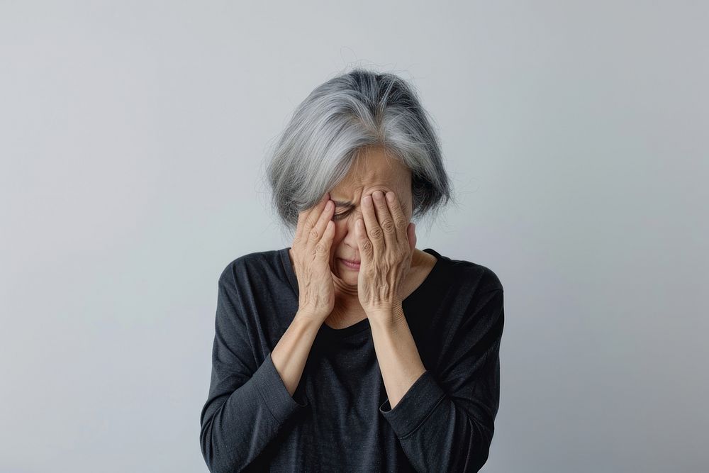 Elderly woman covering face sorrowfully | Free Photo - rawpixel