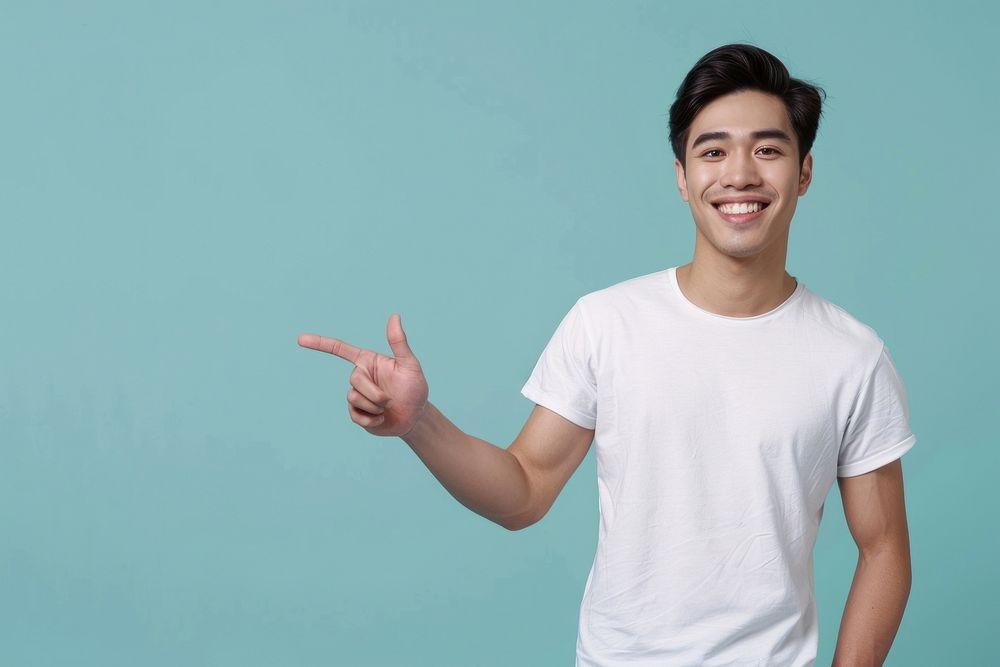 Smiling man pointing right | Free Photo - rawpixel