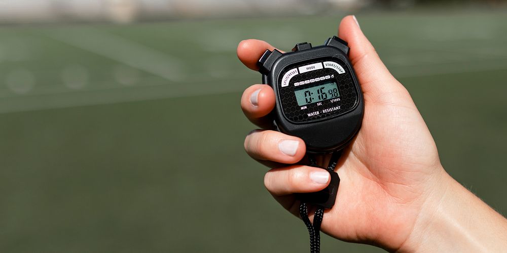 Hand holding digital stopwatch outdoors | Free Photo - rawpixel