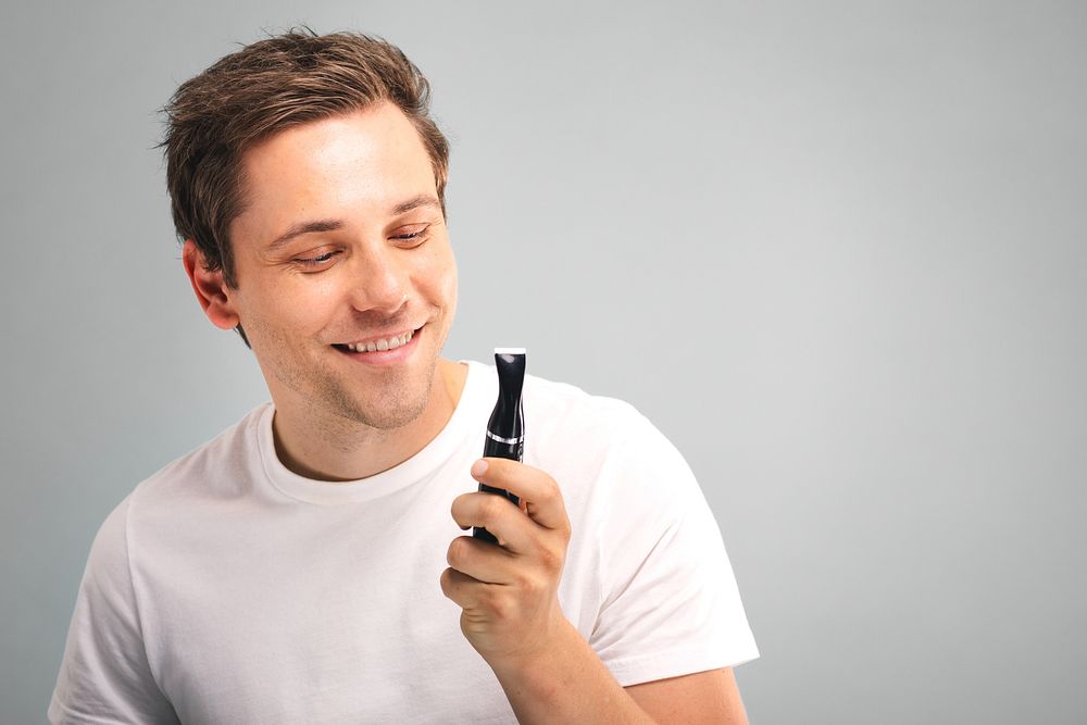 Smiling man holding small black | Premium Photo - rawpixel