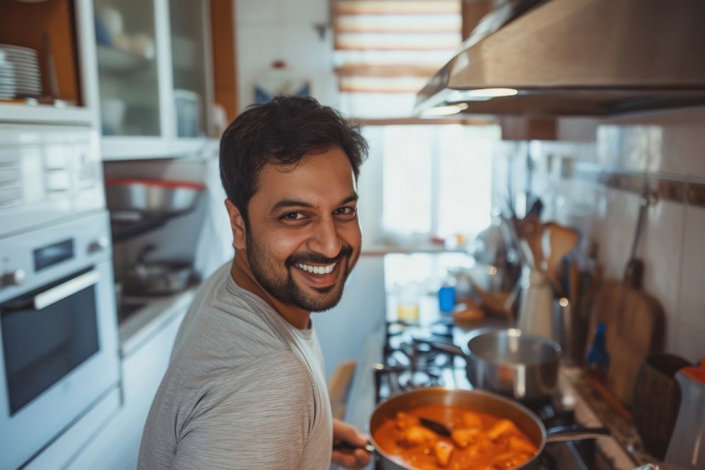 Indian father cooking food smiling | Free Photo - rawpixel