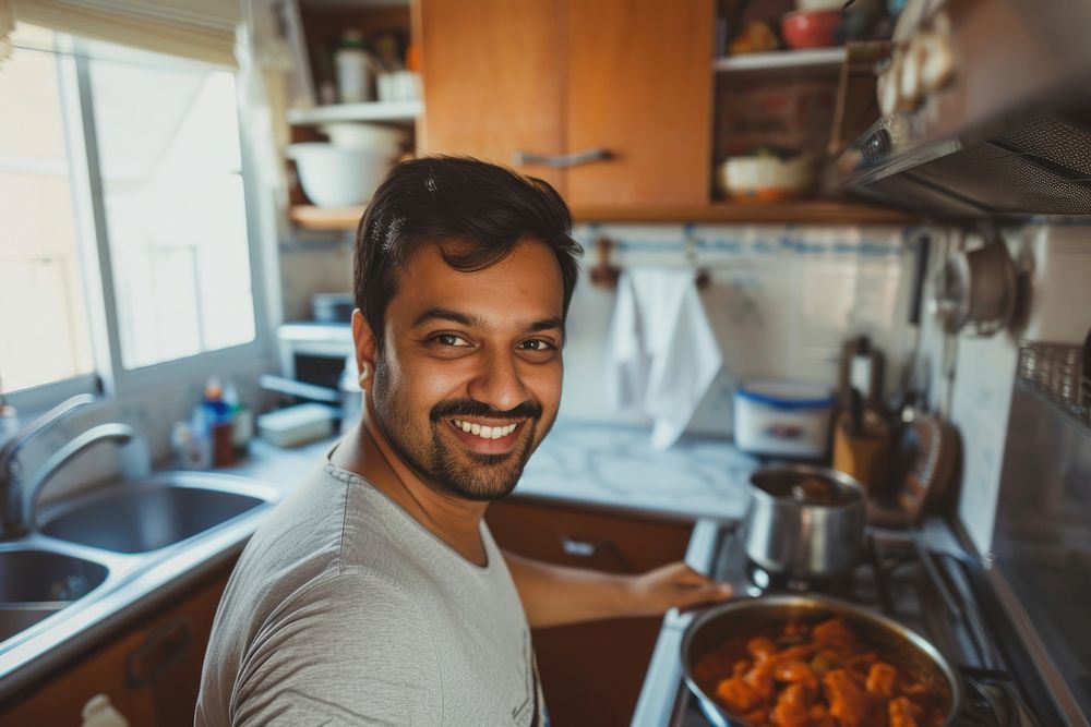 Indian father cooking food smiling | Free Photo - rawpixel