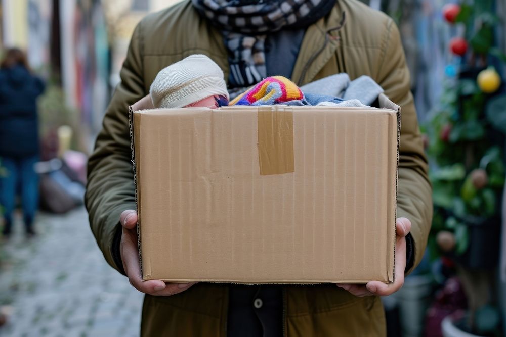 Man holding donation box cardboard | Free Photo - rawpixel Man holding donation box cardboard | Free Photo - rawpixel