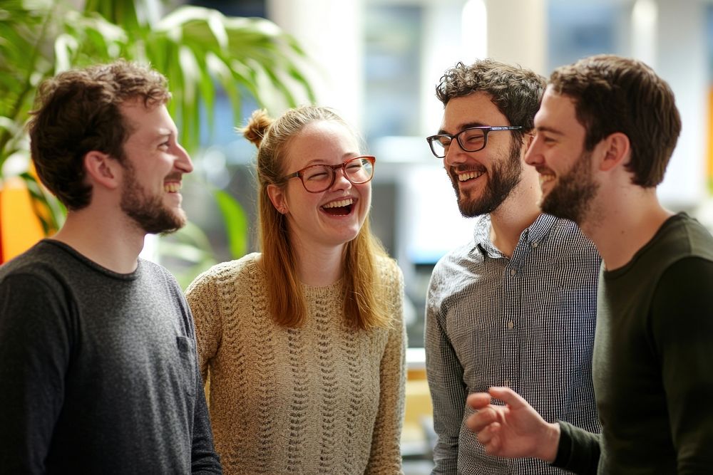 4 colleagues sharing light moment | Free Photo - rawpixel