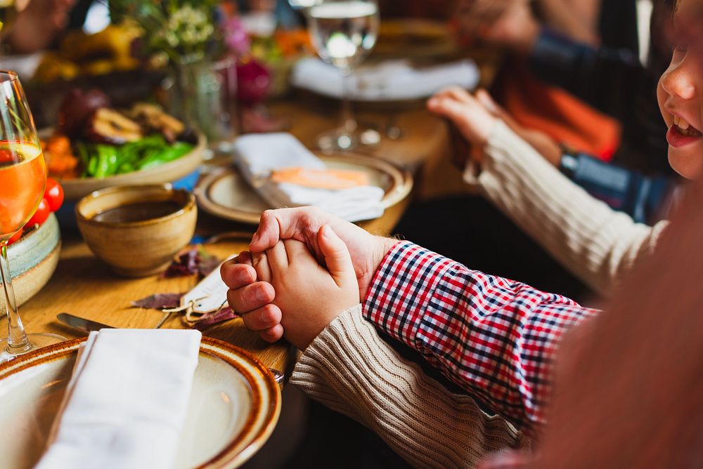 People holding hands dinner table, | Free Photo - rawpixel