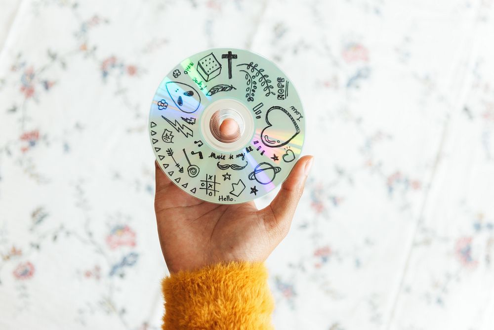 Hand holding decorated CD doodles. | Free Photo - rawpixel