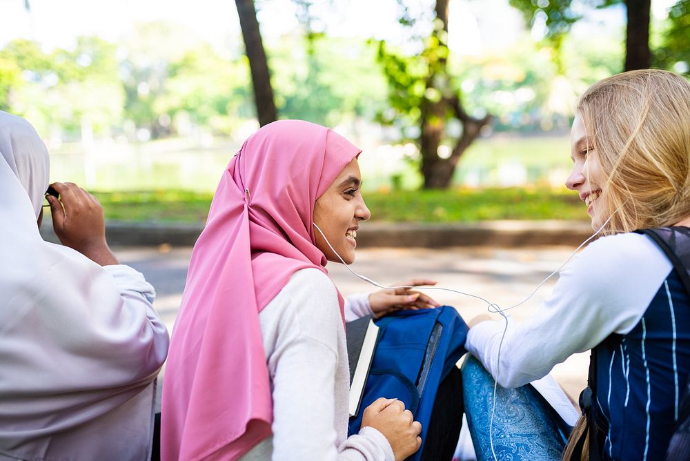 Three women sitting outdoors, sharing | Free Photo - rawpixel
