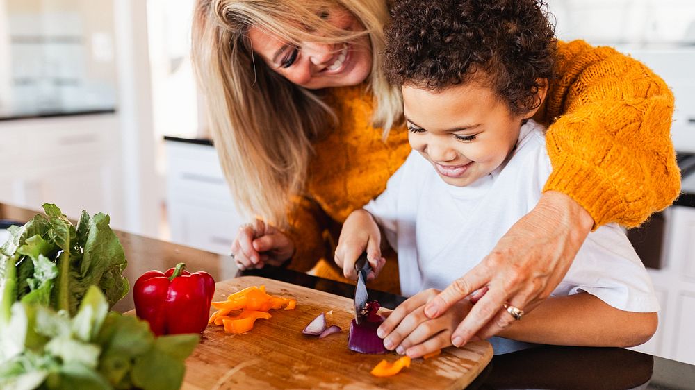 Happy woman helps child chop | Free Photo - rawpixel