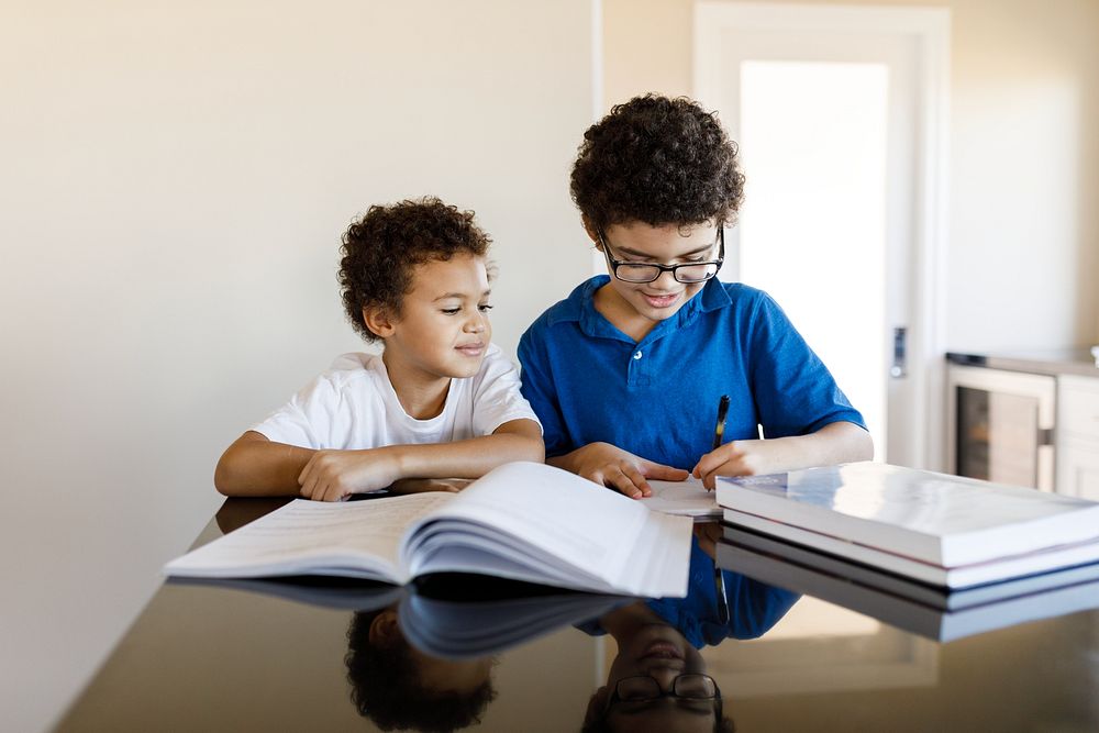 Two children studying together home. | Free Photo - rawpixel