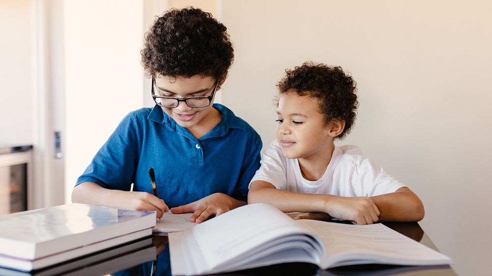 Two children studying together home. | Free Photo - rawpixel