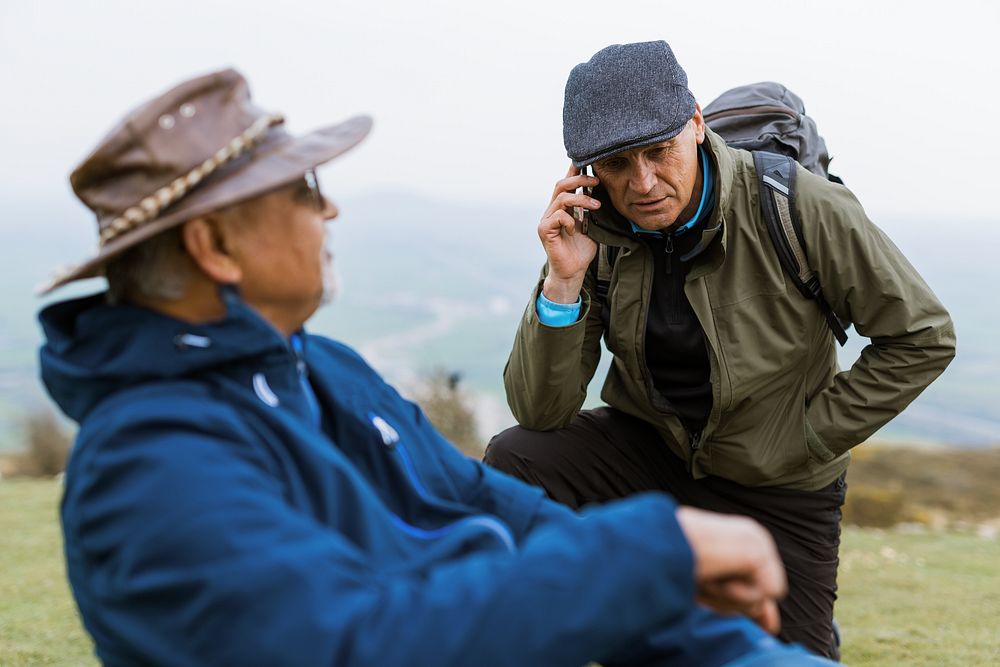 Two men outdoors, one sitting, | Premium Photo - rawpixel