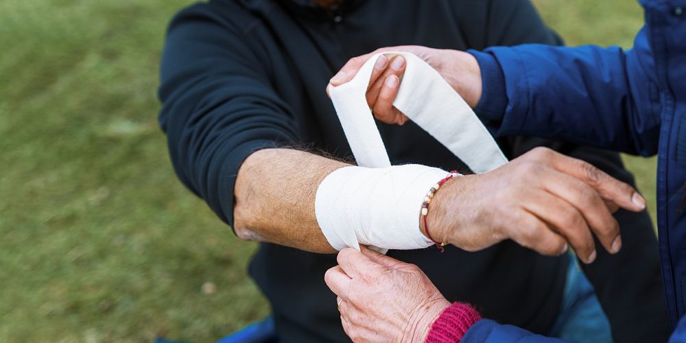 Close-up person bandaging another's arm | Premium Photo - rawpixel