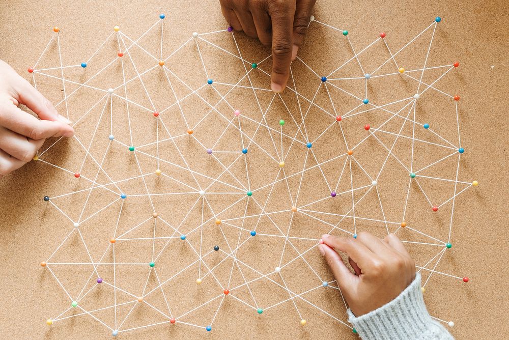 Hands connecting strings corkboard, symbolizing | Free Photo - rawpixel
