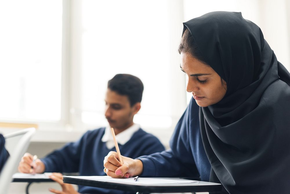 Muslim students classroom, focused writing. | Free Photo - rawpixel