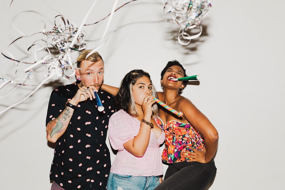 Three people celebrating party blowers | Free Photo - rawpixel