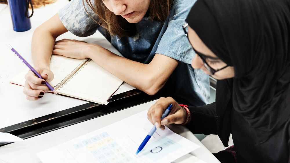Two people collaborating, taking notes, | Premium Photo - rawpixel
