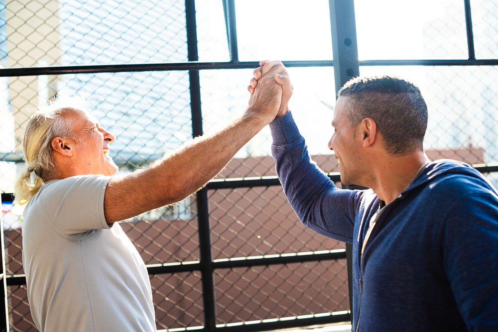 Two people high-fiving outdoors, celebrating | Free Photo - rawpixel
