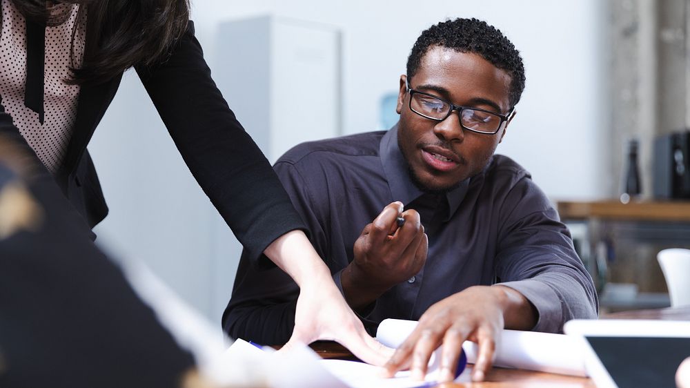 Two people collaborating desk, discussing | Free Photo - rawpixel