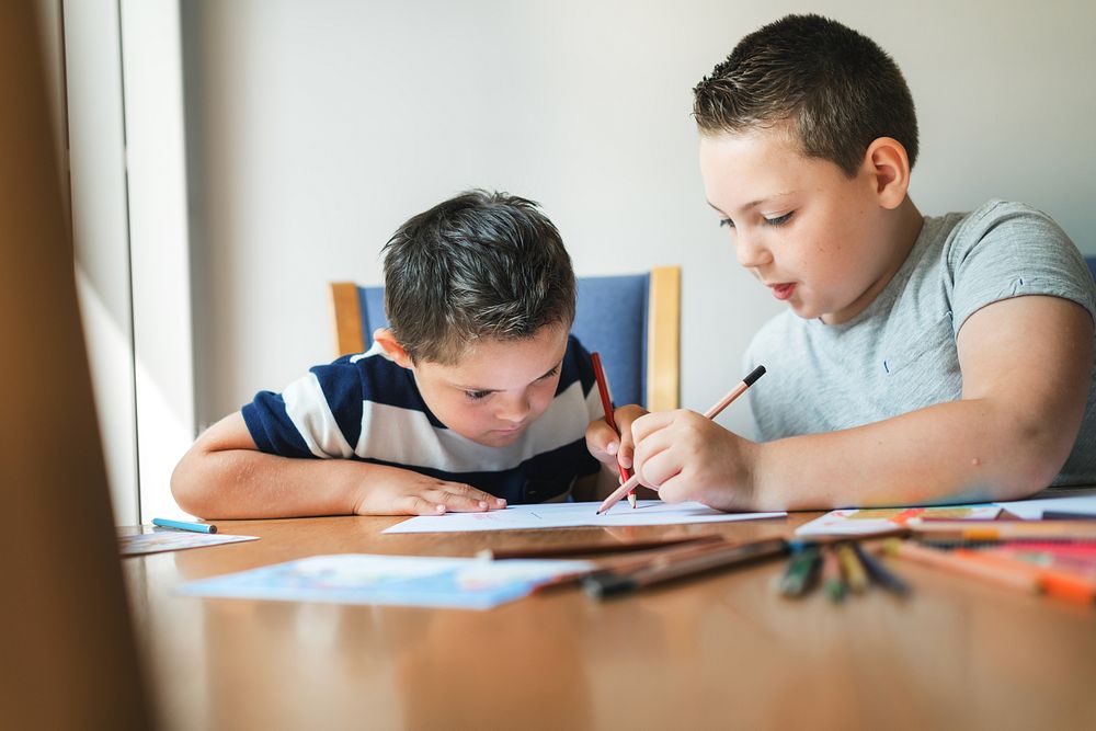 Two young boys drawing table, | Free Photo - rawpixel