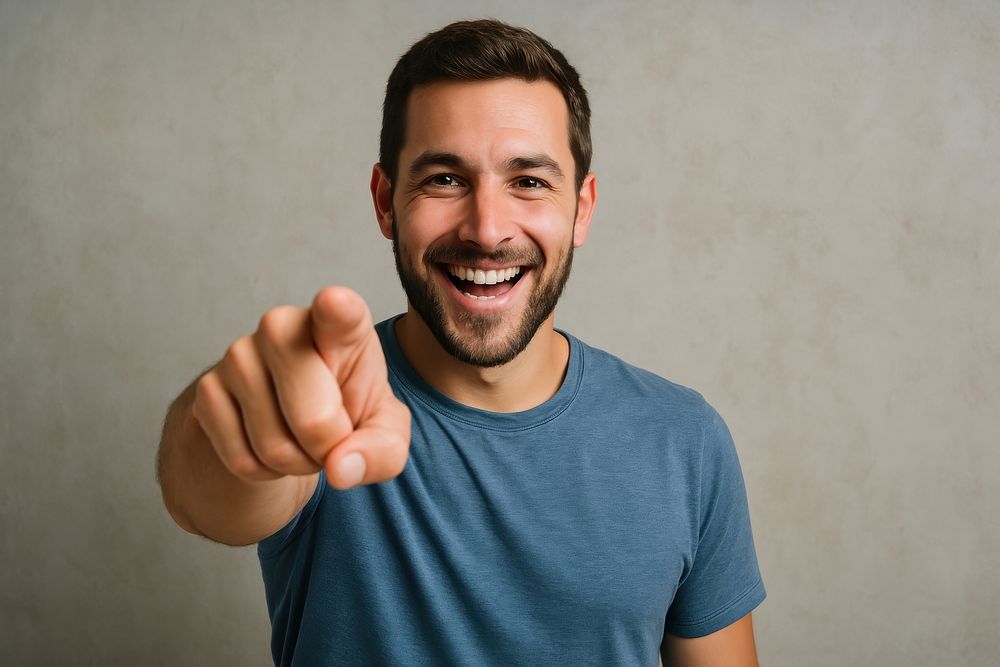Happy man pointing forward smiling | Free Photo - rawpixel