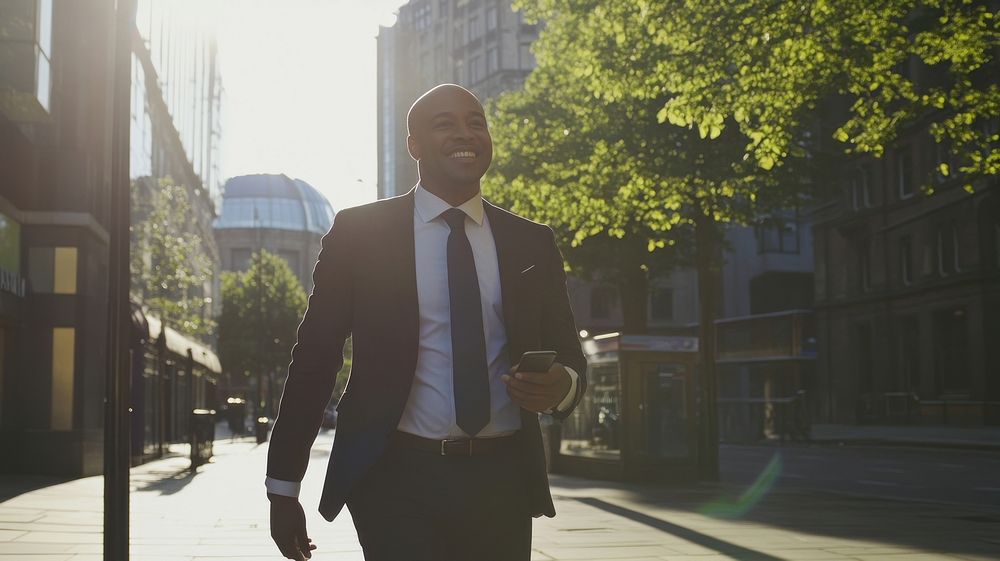 Businessman walking phone city. | Free Photo - rawpixel