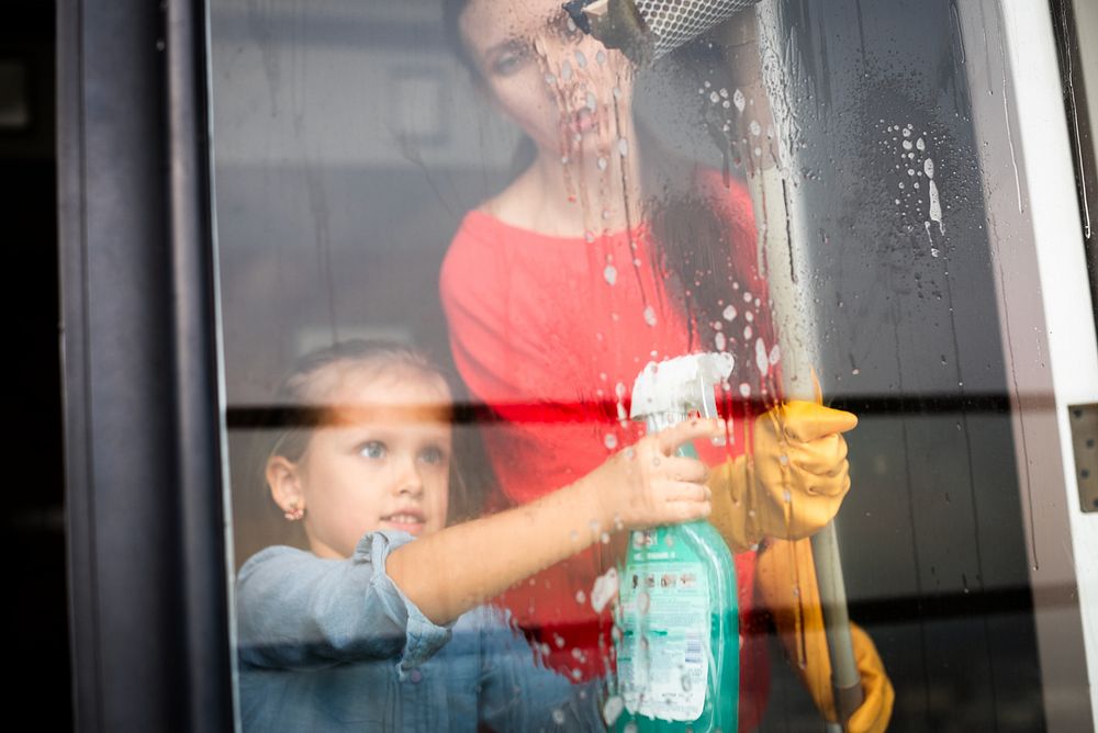 Woman and child cleaning window. | Free Photo - rawpixel