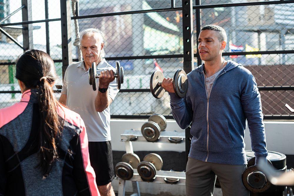 Two men lifting dumbbells gym. | Free Photo - rawpixel