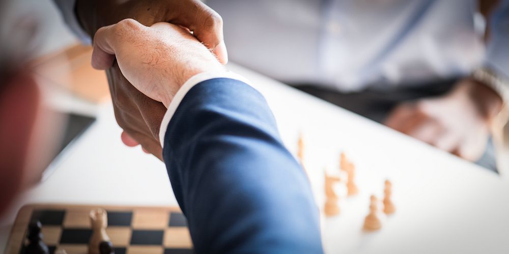 Close-up handshake chessboard, symbolizing agreement | Free Photo ...