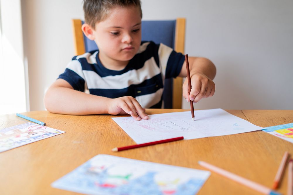 Young boy drawing colored pencils | Free Photo - rawpixel