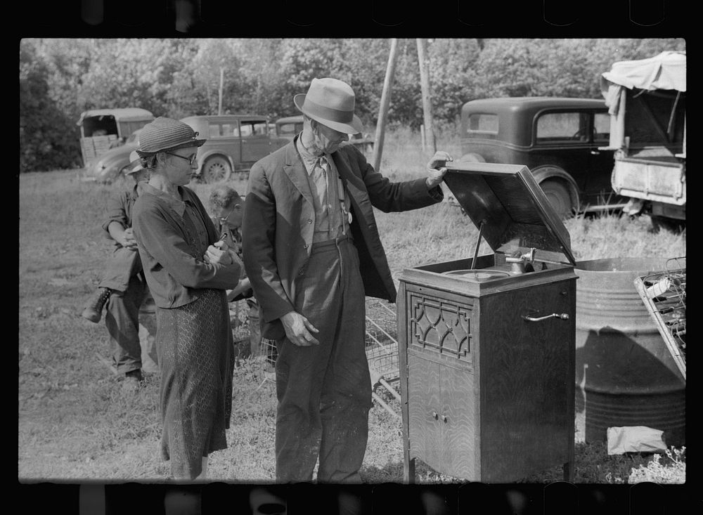 Farmer and wife examining phonograph | Free Photo - rawpixel