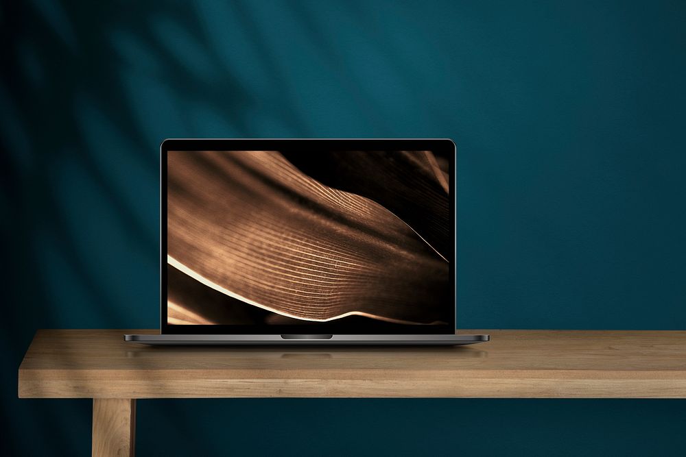 Laptop wooden table, blue wall | Premium Photo - rawpixel