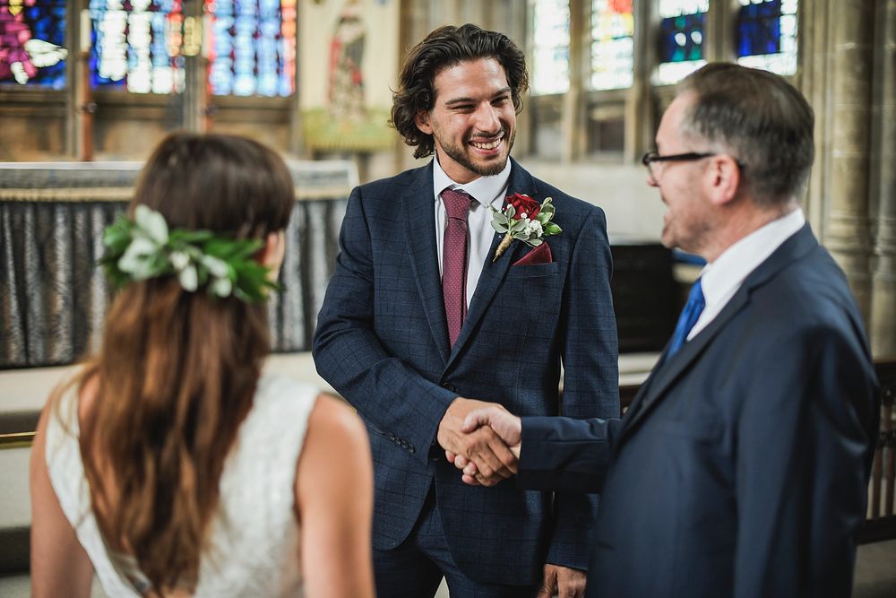 Groom shaking hands with the father | Photo - rawpixel