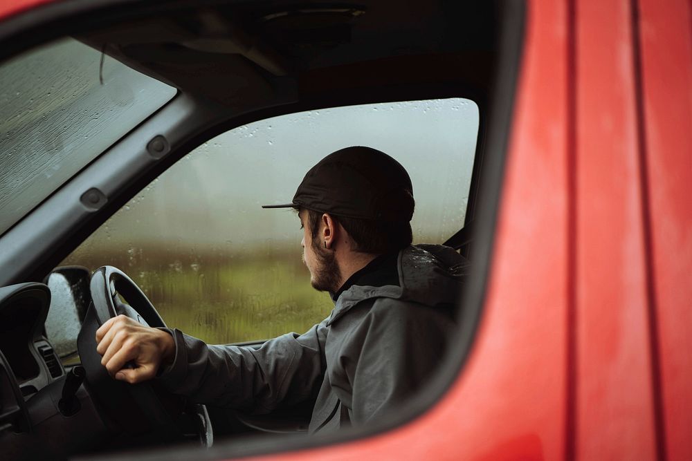 Man driving red van while | Premium Photo - rawpixel