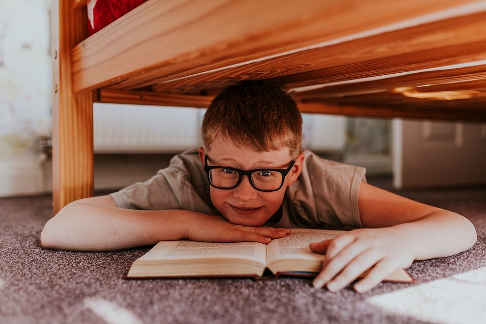 Boy reading book his bed | Premium Photo - rawpixel
