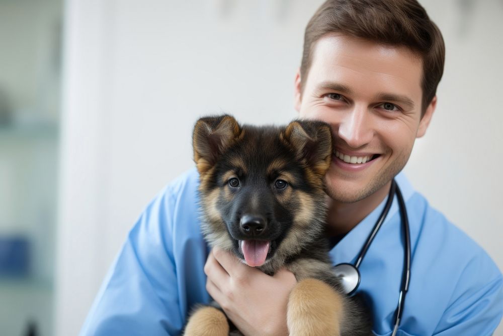 Doctor holding german shepherd puppy | Premium Photo - rawpixel