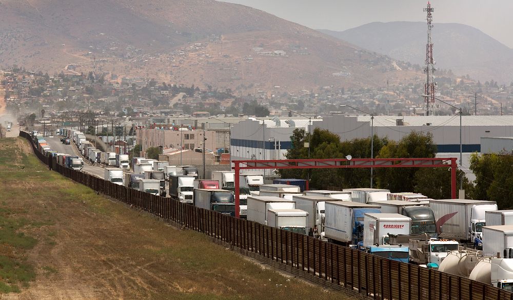 long line tractor-trailers await entry | Free Photo - rawpixel