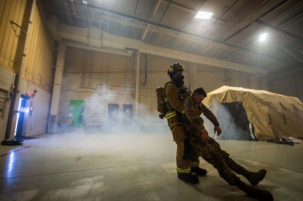 firefighter carries simulated casualty hazardous | Free Photo - rawpixel