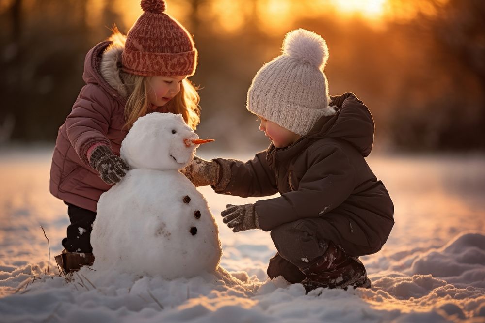 Two kids building snow man | Free Photo - rawpixel