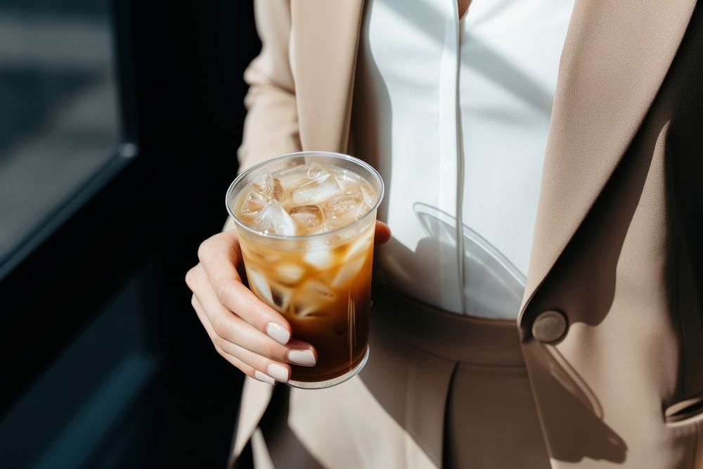 Standing holding coffee drink. | Free Photo - rawpixel