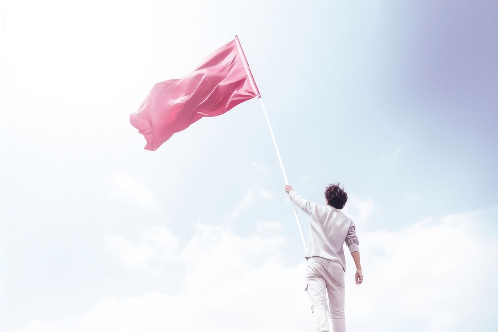 person raising flag sky white | Premium Photo - rawpixel