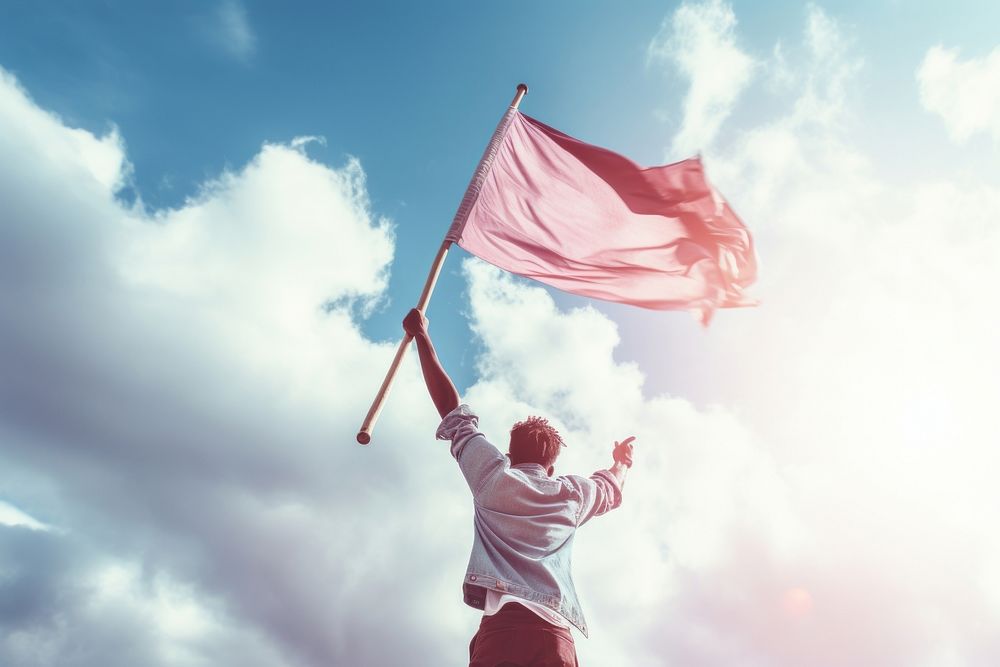 person raising flag sky success | Premium Photo - rawpixel