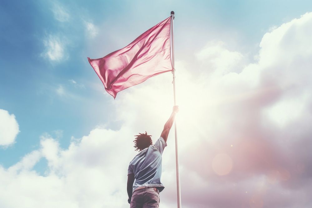 person raising flag sky patriotism | Premium Photo - rawpixel